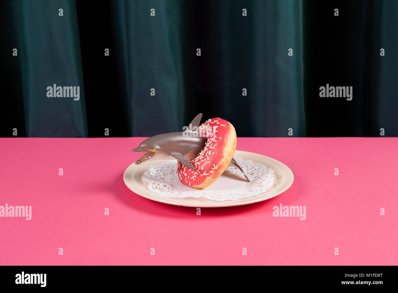 a dolphin plastic toy inside a donut symbolizing a buoy on a vibrant ...