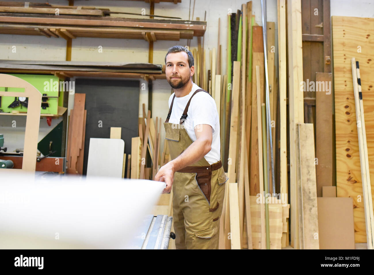 portrait of a worker in a joinery at the workplace - woodworking Stock ...