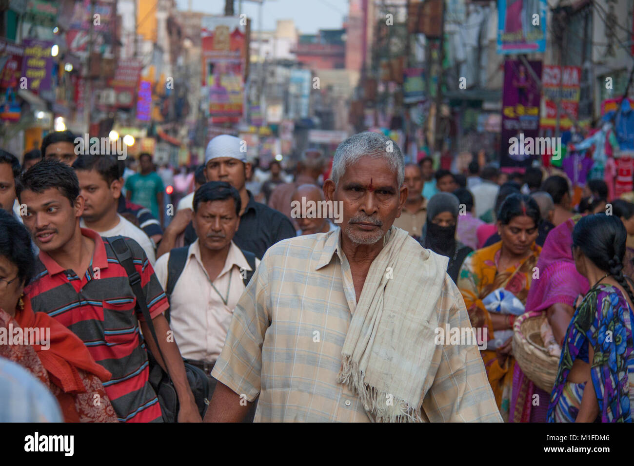 Crowd walking along the main street in Varanasi, Uttah Pradesh, India ...