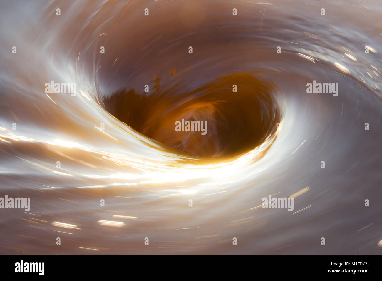 A extreme close up of a small swirling circular motion of a water ...