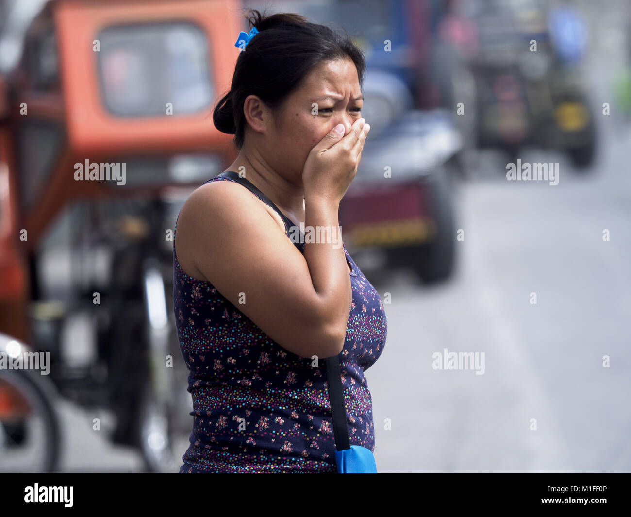 Guinobatan, Albay, Philippines. 30th Jan, 2018. A woman covers her ...