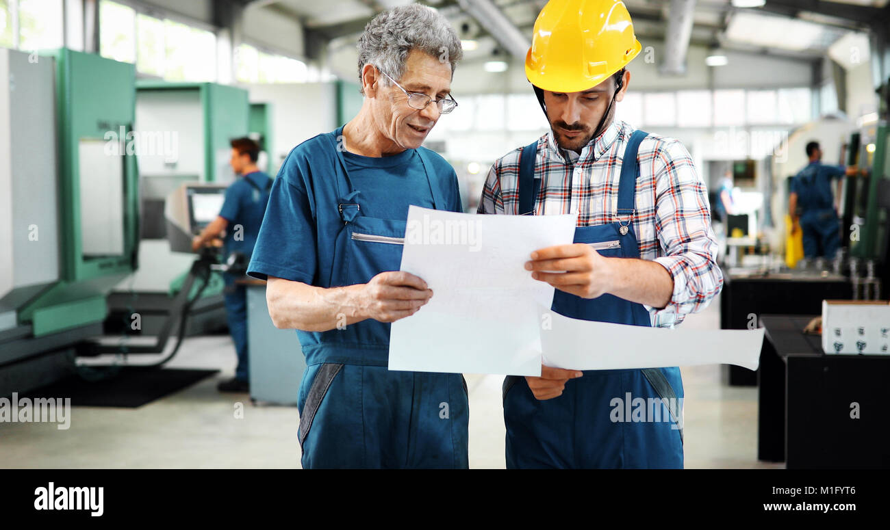 Engineer Teaching Apprentices To Use Computerized cnc metal processing ...