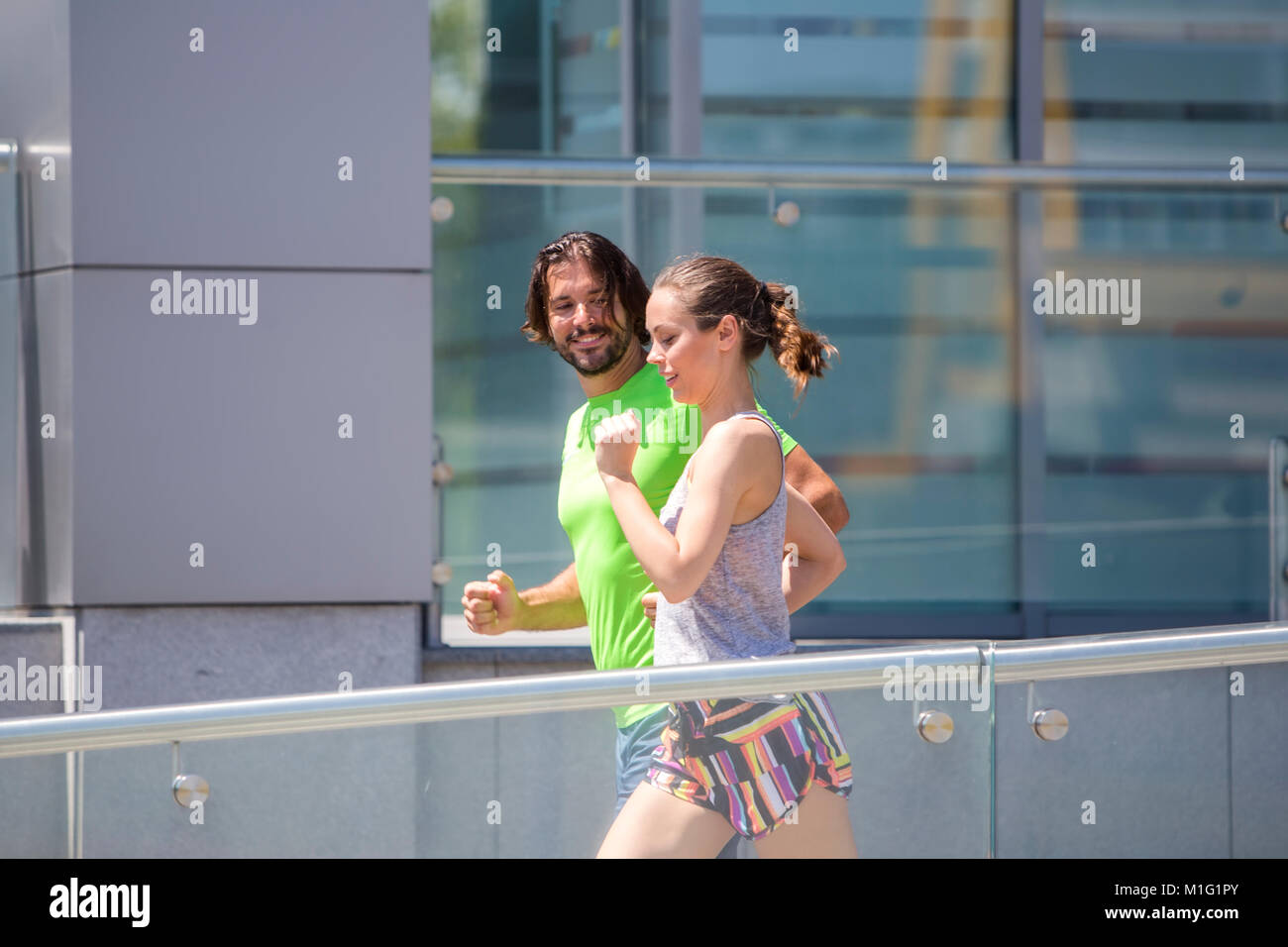 Couple running in urban enviroment at hot summer day Stock Photo - Alamy