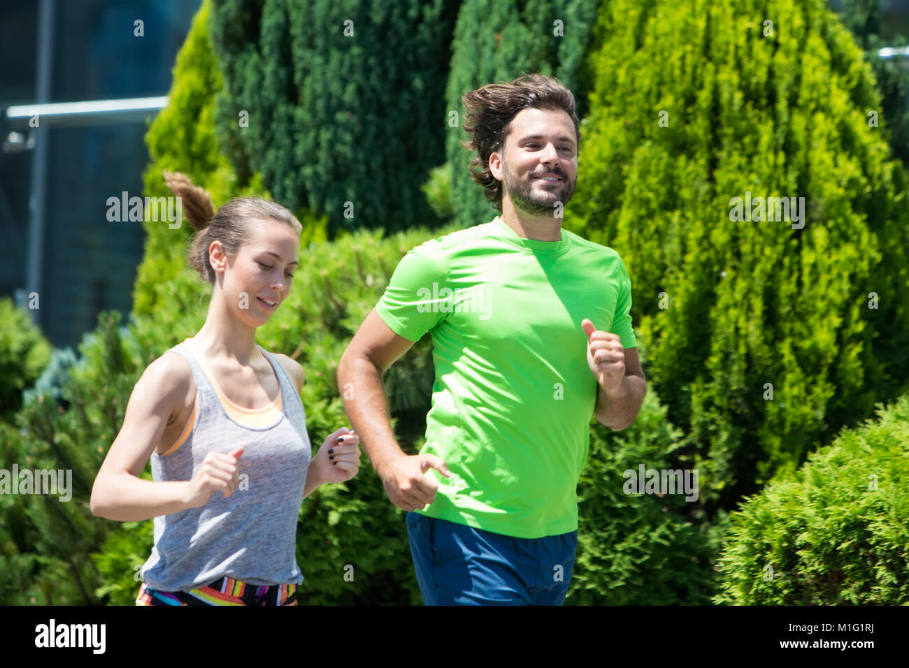 Couple running in urban enviroment at hot summer day Stock Photo - Alamy