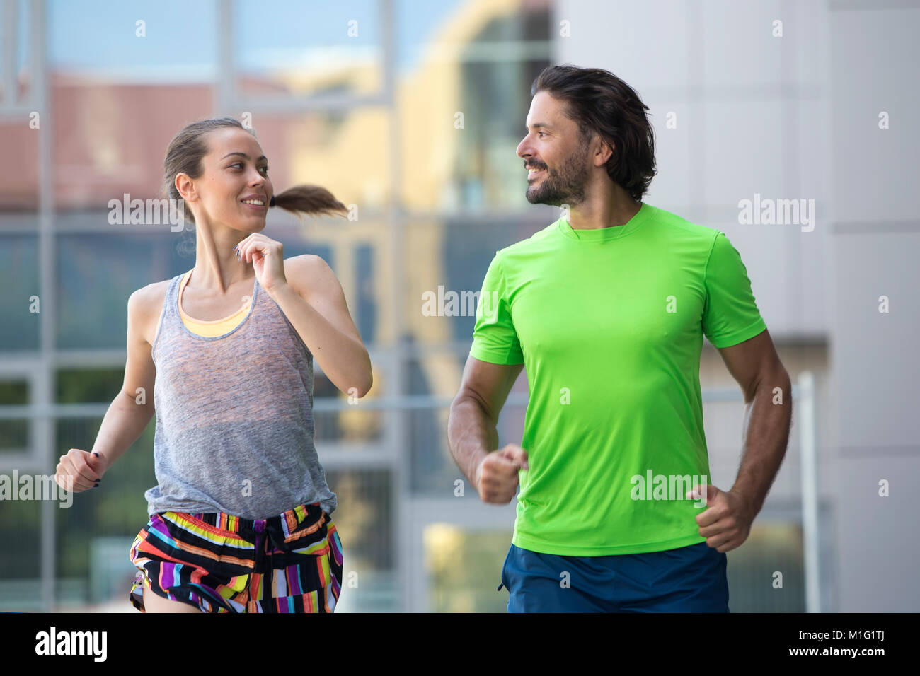 Couple running in urban enviroment at hot summer day Stock Photo - Alamy