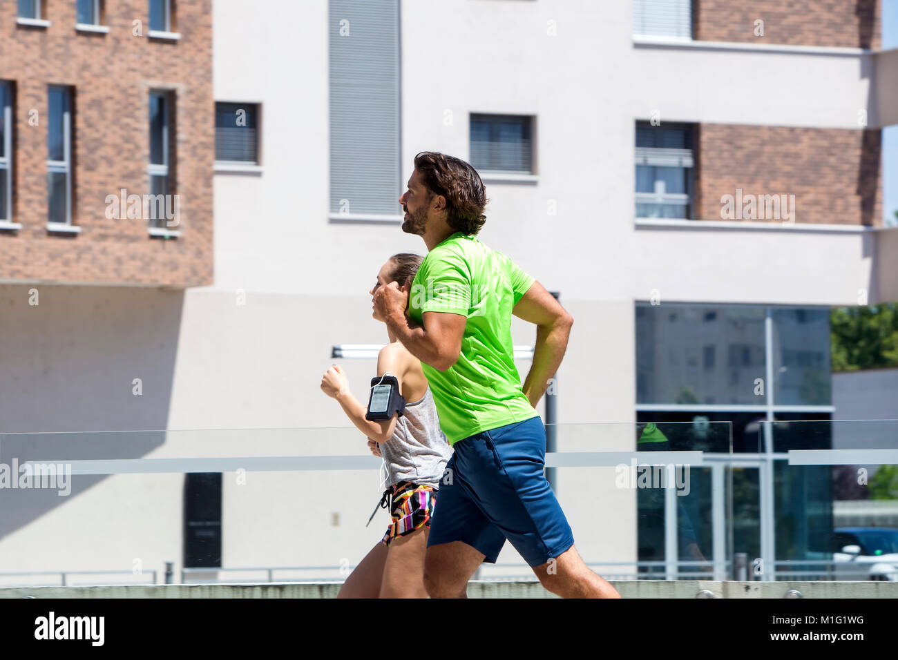 Couple running in urban enviroment at hot summer day Stock Photo - Alamy