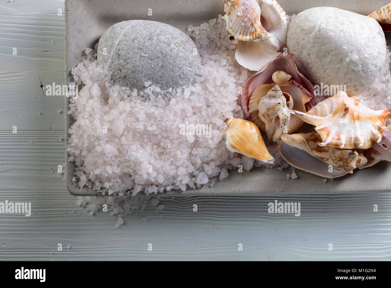 Sea salt with stones and shells on white wooden table.Top view Stock ...