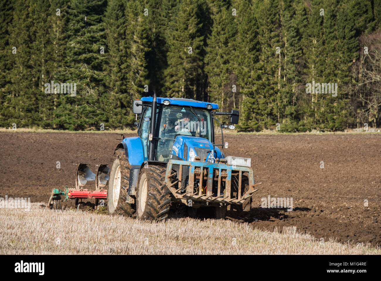 A tractor ploughing on the Haddo Estate in rural Aberdeenshire ...