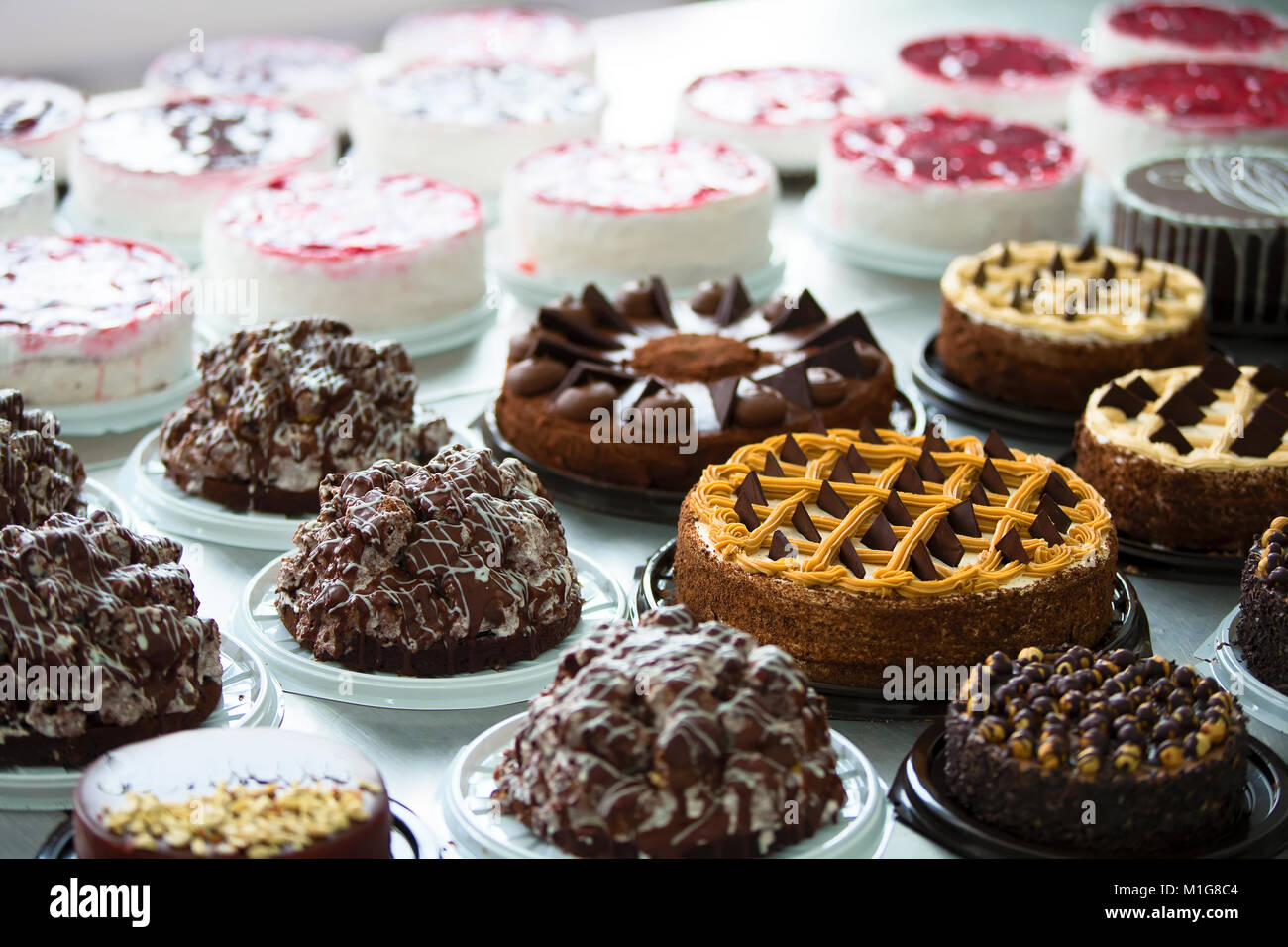 Many cakes on the table. Industrial Cake Line Stock Photo - Alamy