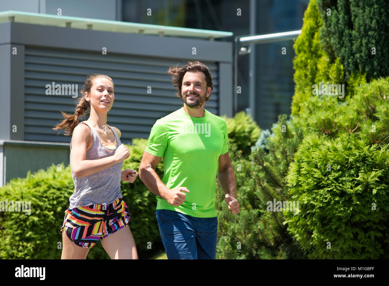 Couple running in urban enviroment at hot summer day Stock Photo - Alamy