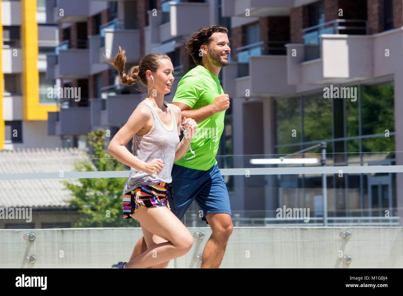 Couple running in urban enviroment at hot summer day Stock Photo - Alamy