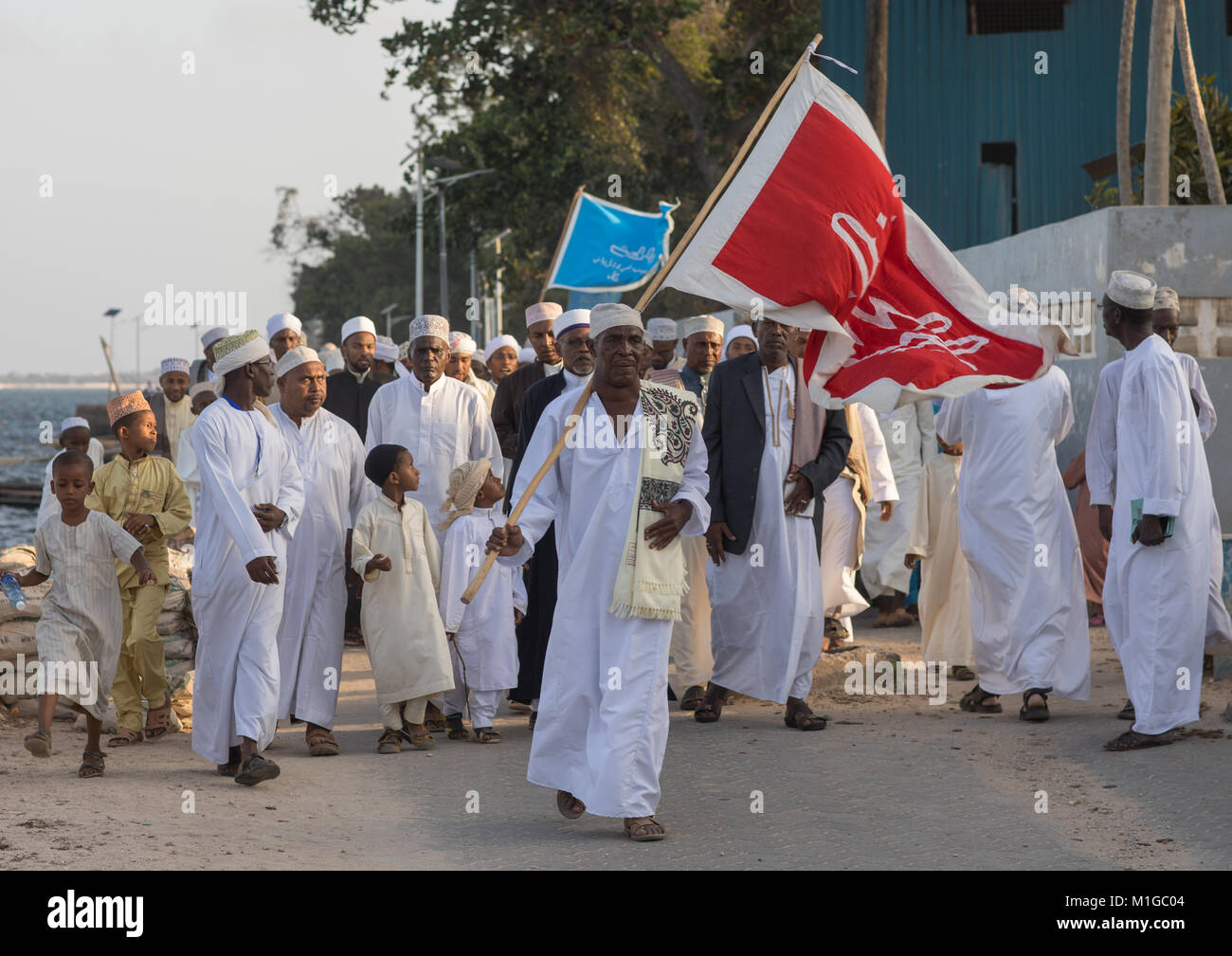 Sunni muslim people parading with flags during the Maulidi festivities ...