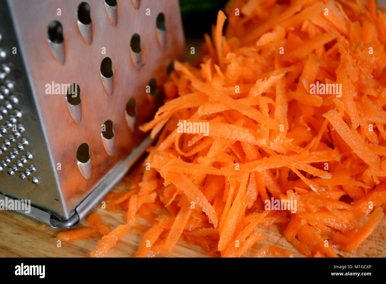 Grated Carrot By Grater Stock Photo - Alamy