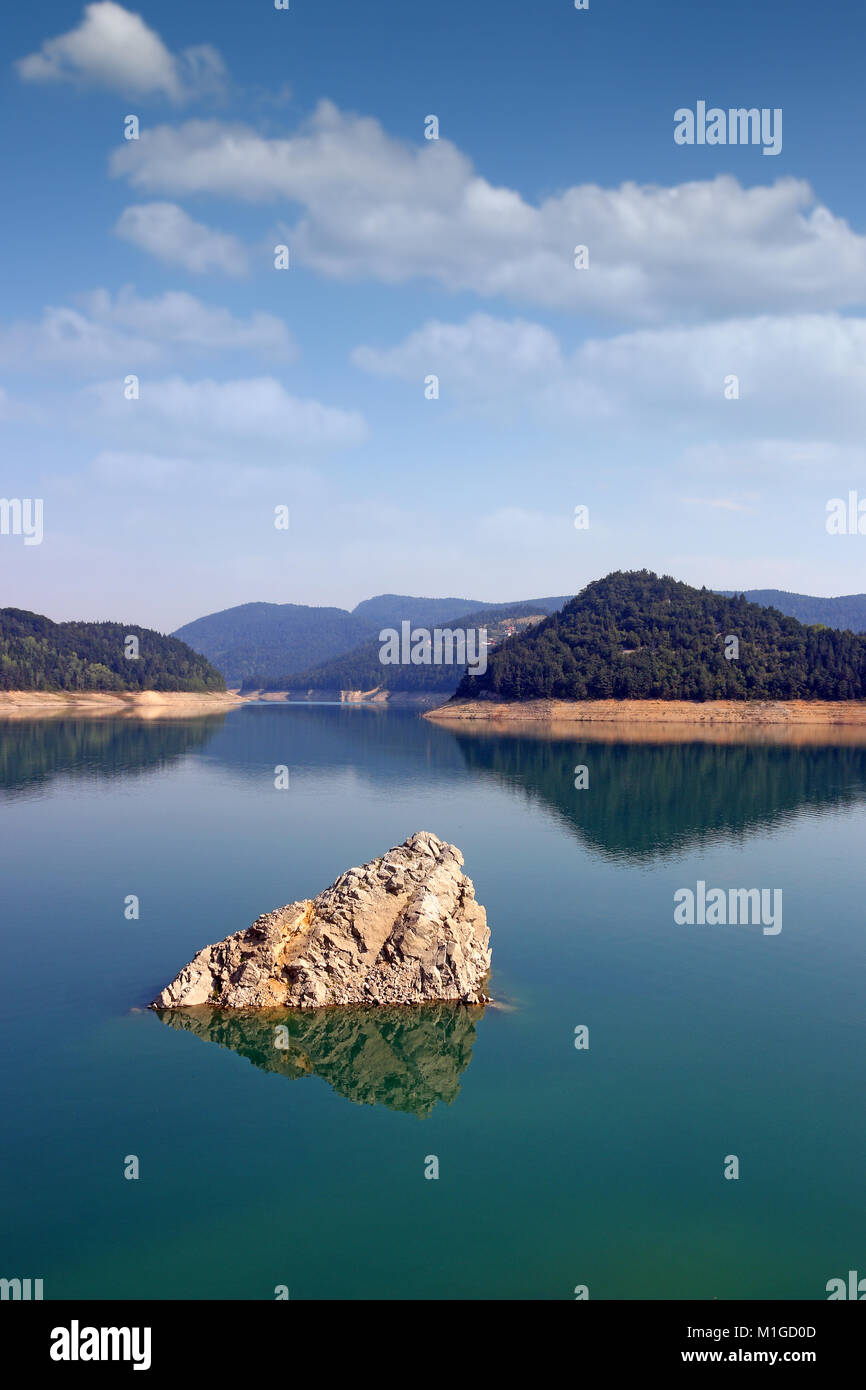 rock in the lake landscape Stock Photo - Alamy