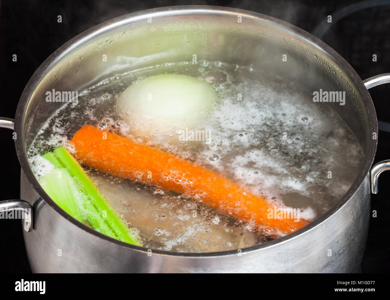 cooking soup - boiling meat broth in stew pan close up Stock Photo - Alamy