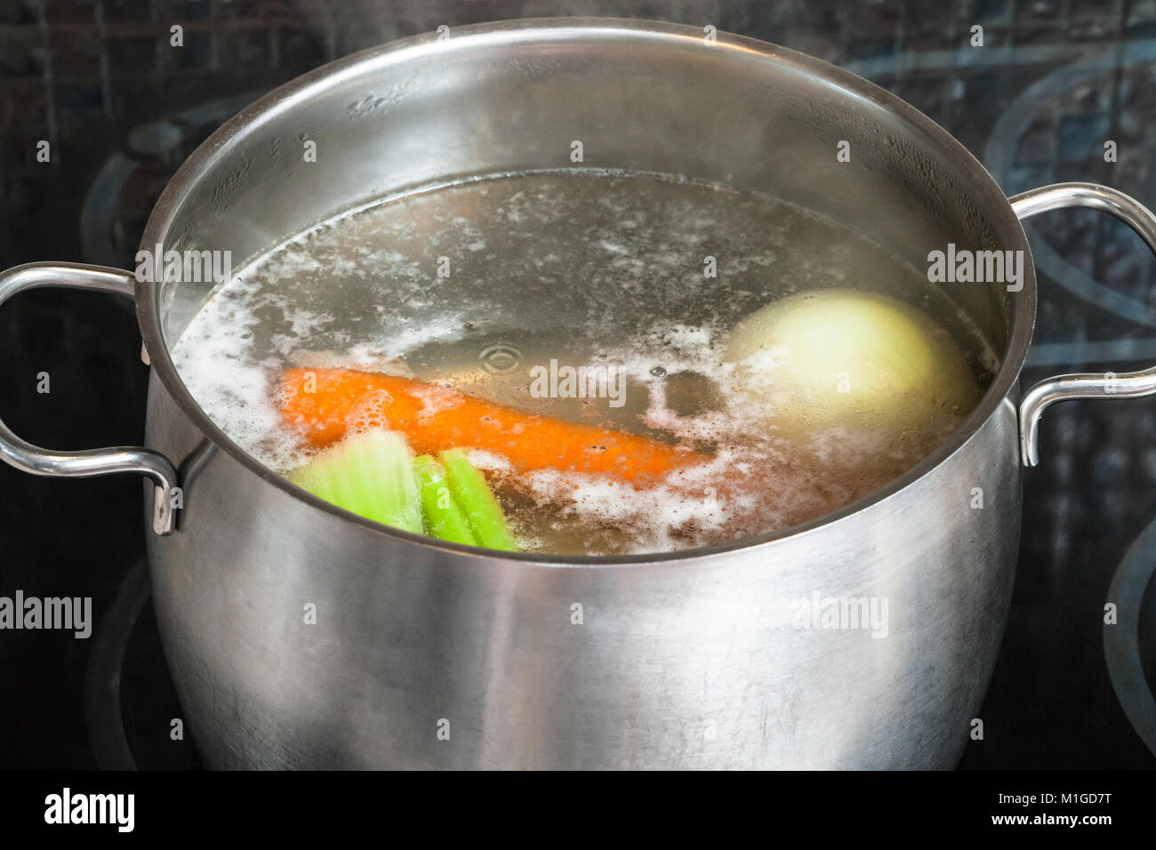 cooking soup - boiling meat broth in steel stockpot Stock Photo - Alamy