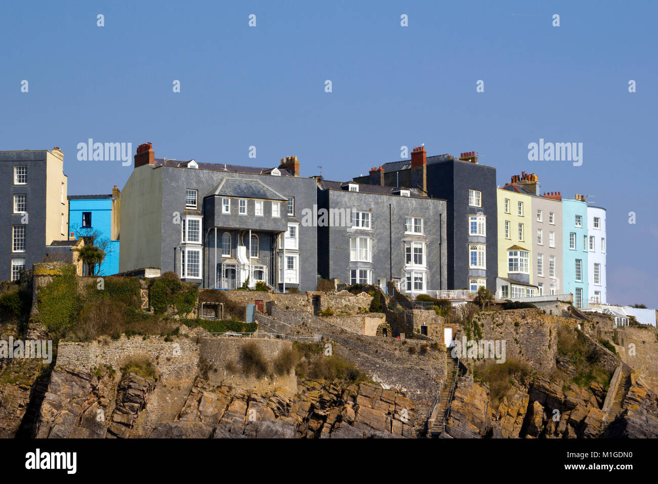 A vibrant blue painted house stands out amongst grey houses on the ...