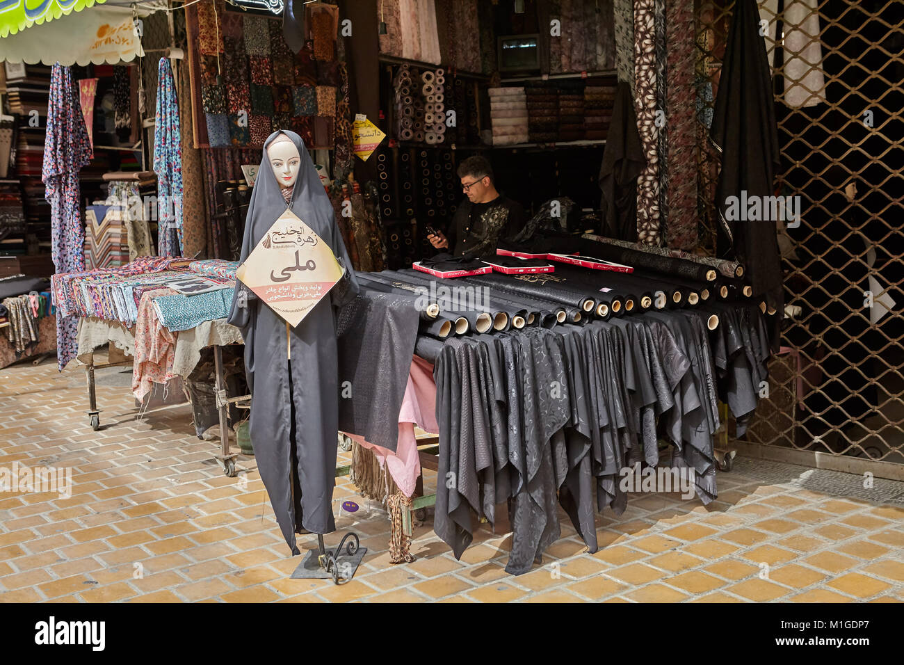 Isfahan, Iran - April 24, 2017: an Iranian trader sits in a tent with ...