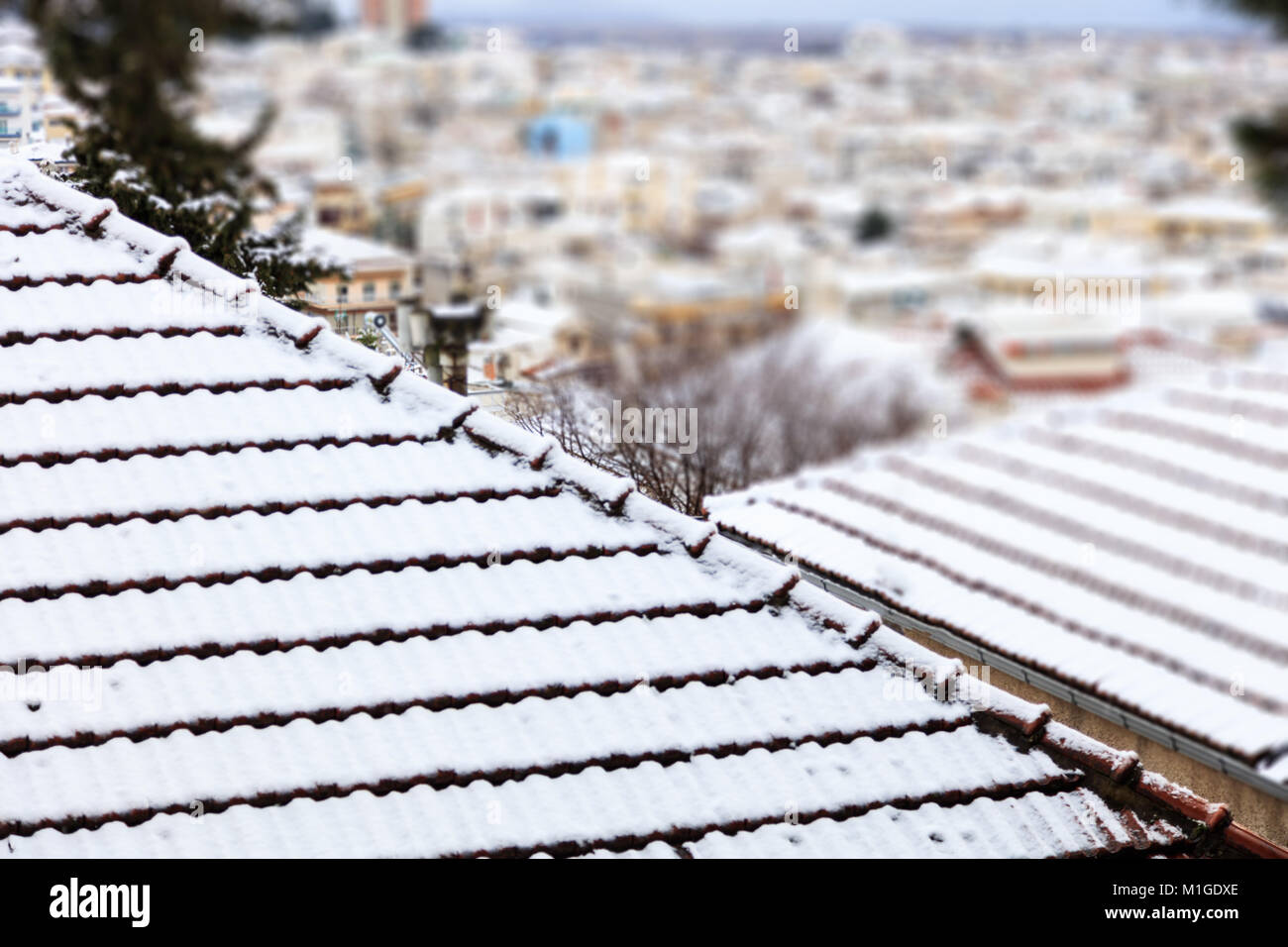 Rooftops full of white, soft snow. Winter, time for holiday. Blur town ...