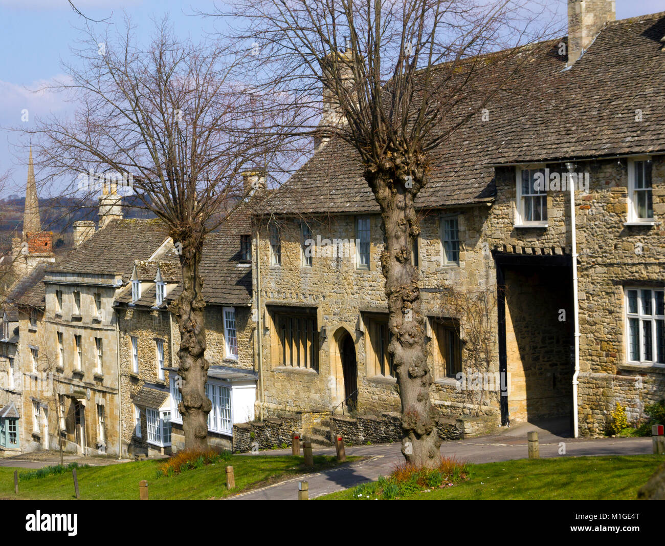Quaint Cotswold cottages in early spring sunshine on The Hill, Burford ...