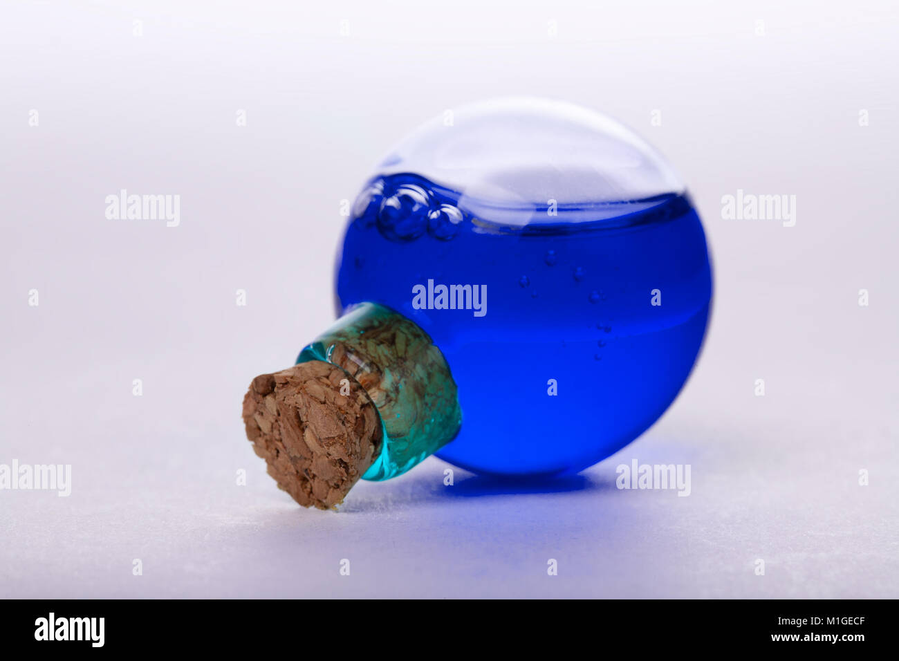 blue liquid in old style vial. close up Stock Photo - Alamy