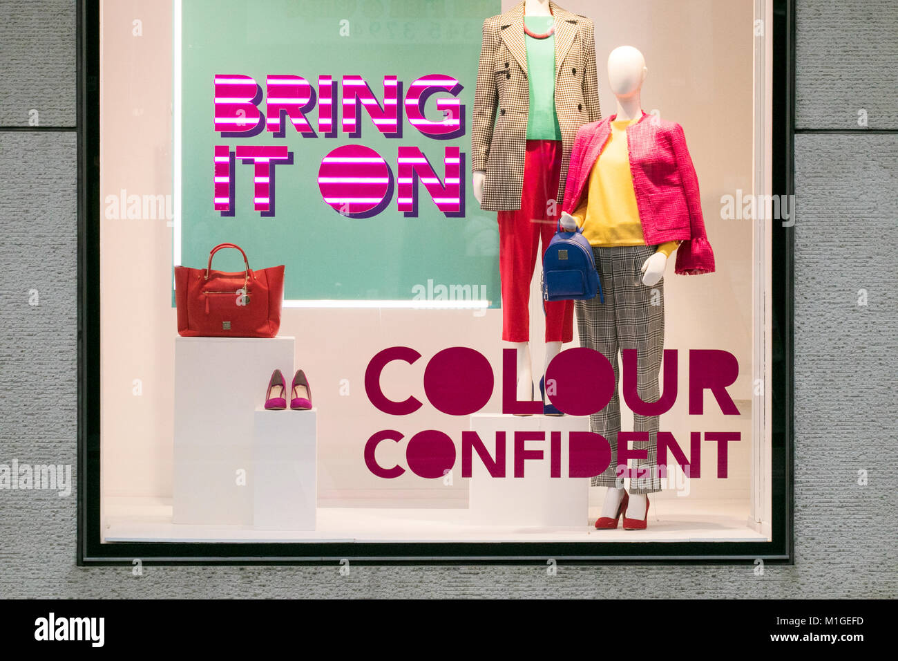 Clothing store shop window displays showing the latest retail products ...