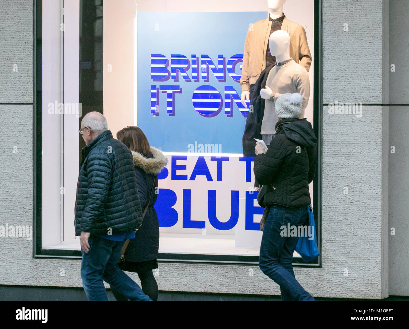 Clothing store shop window displays showing the latest retail products ...