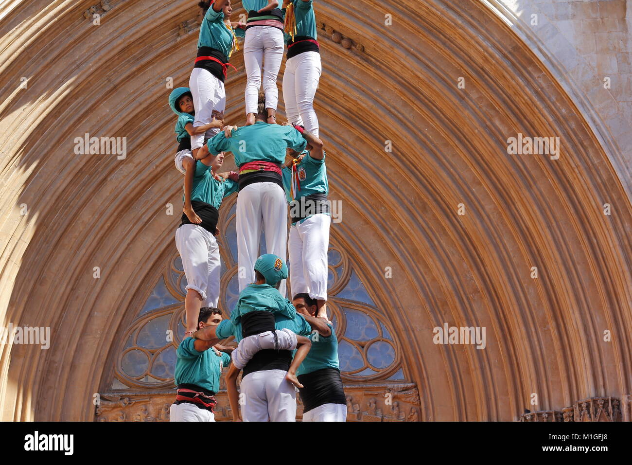 People making human towers in front of the cathedral, a traditional ...
