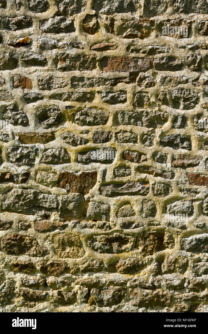 A neatly pointed restored stone wall full frame texture background ...