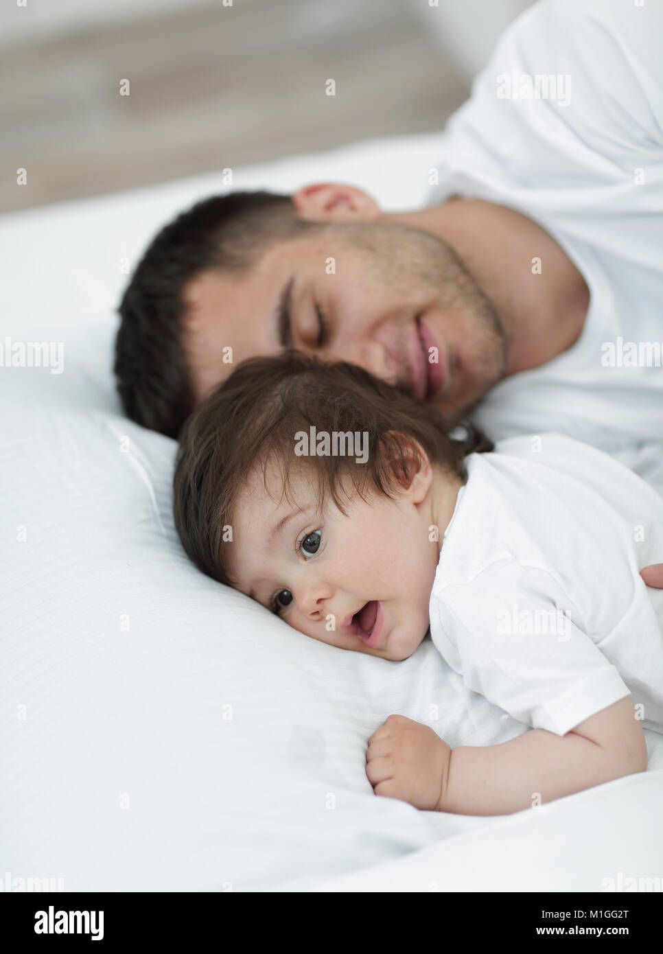 father and baby sleeping peacefully in bed Stock Photo - Alamy
