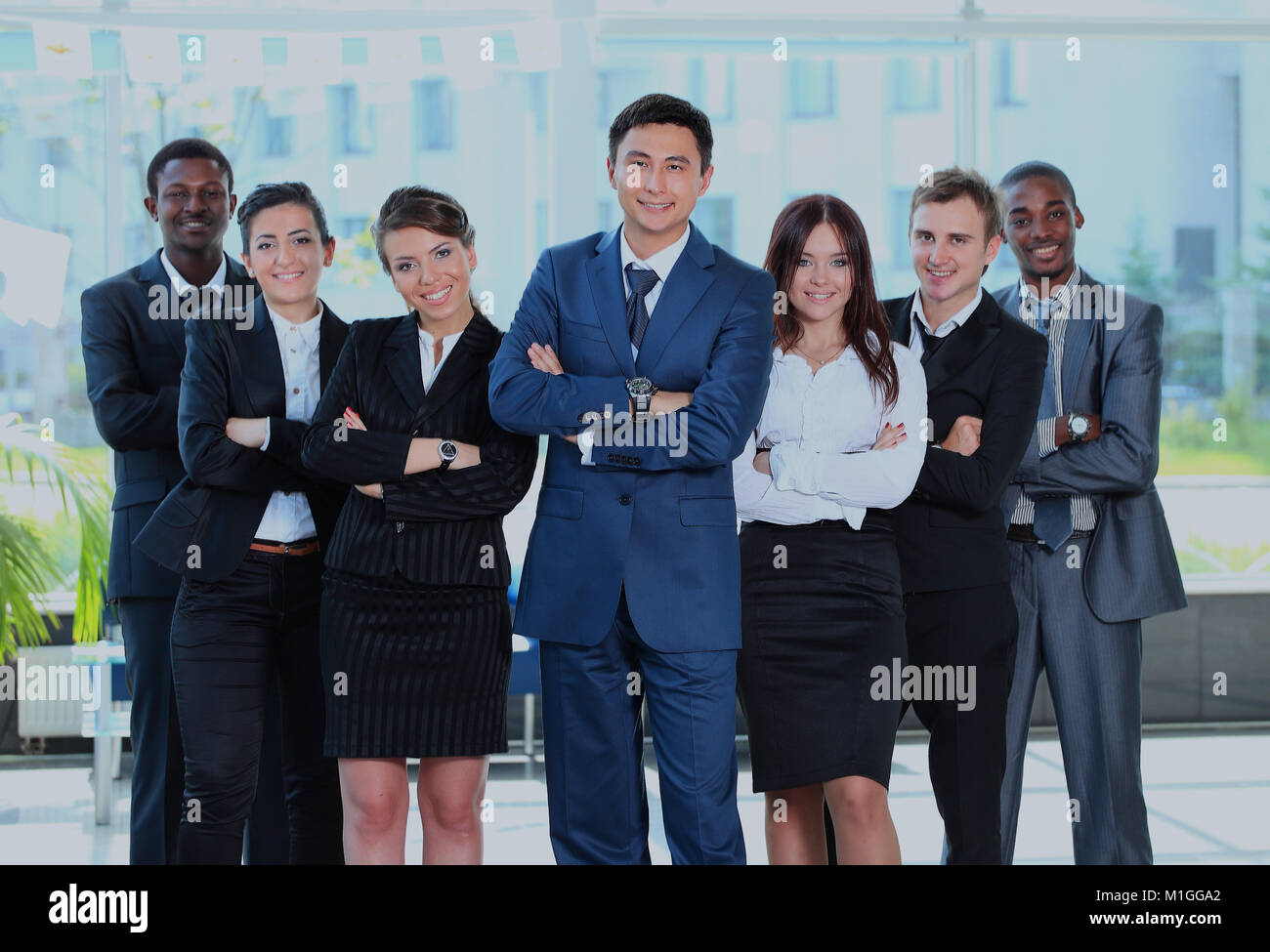 Portrait of businessman leading his team at office Stock Photo - Alamy