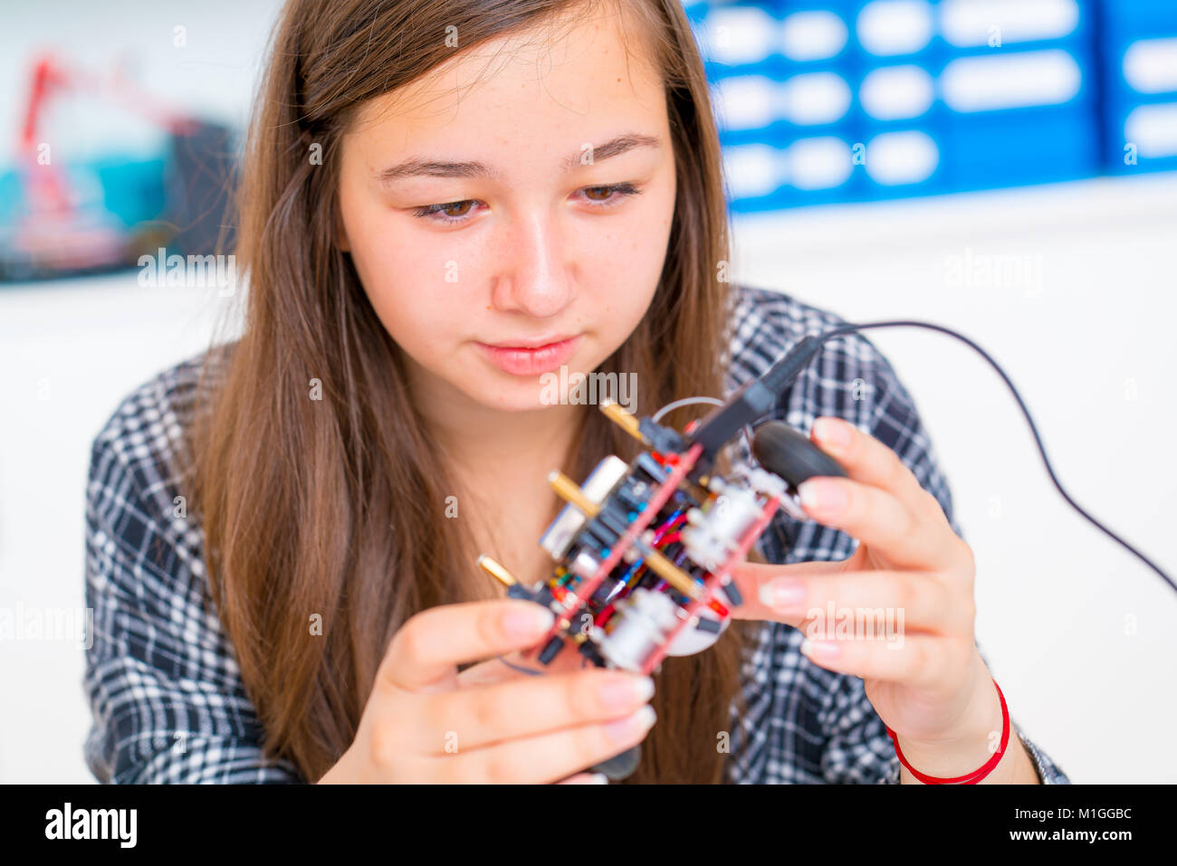 Schoolgirl in the school robotics laboratory with a robot model Stock ...