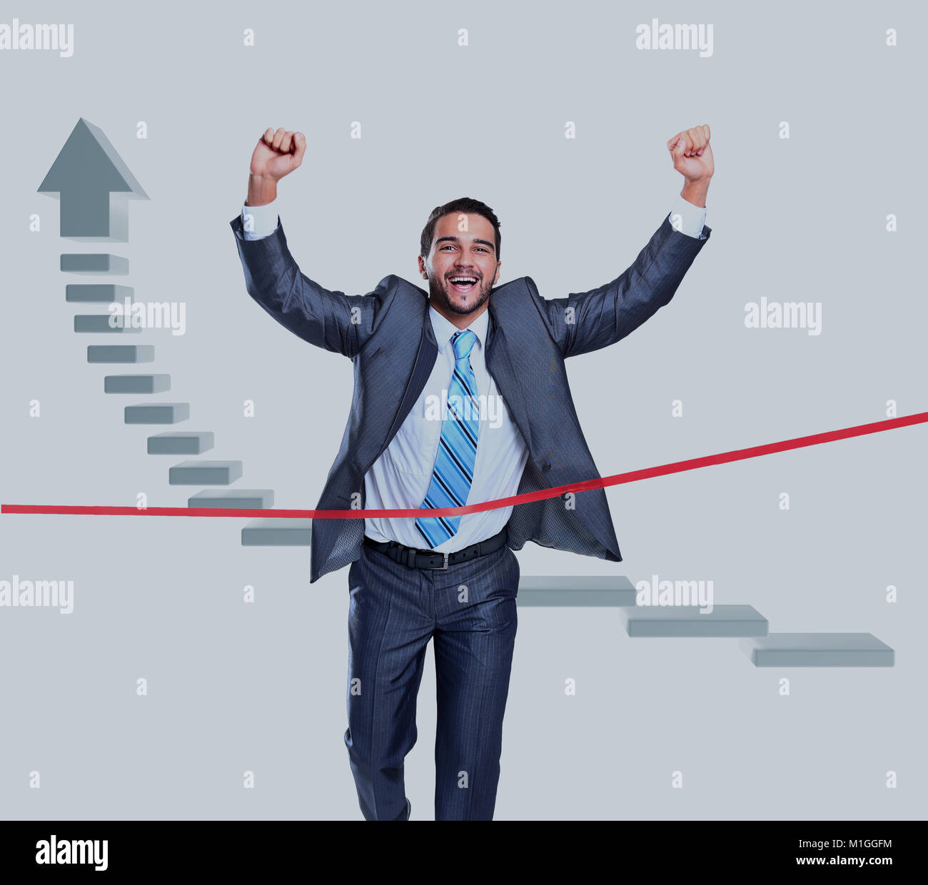 Happy businessman running through finishing line Stock Photo - Alamy