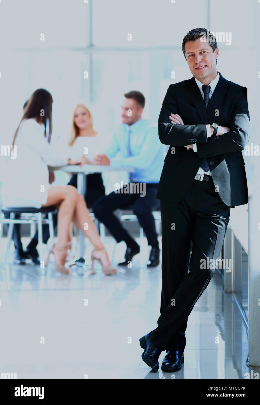 businessman standing with his team Stock Photo - Alamy