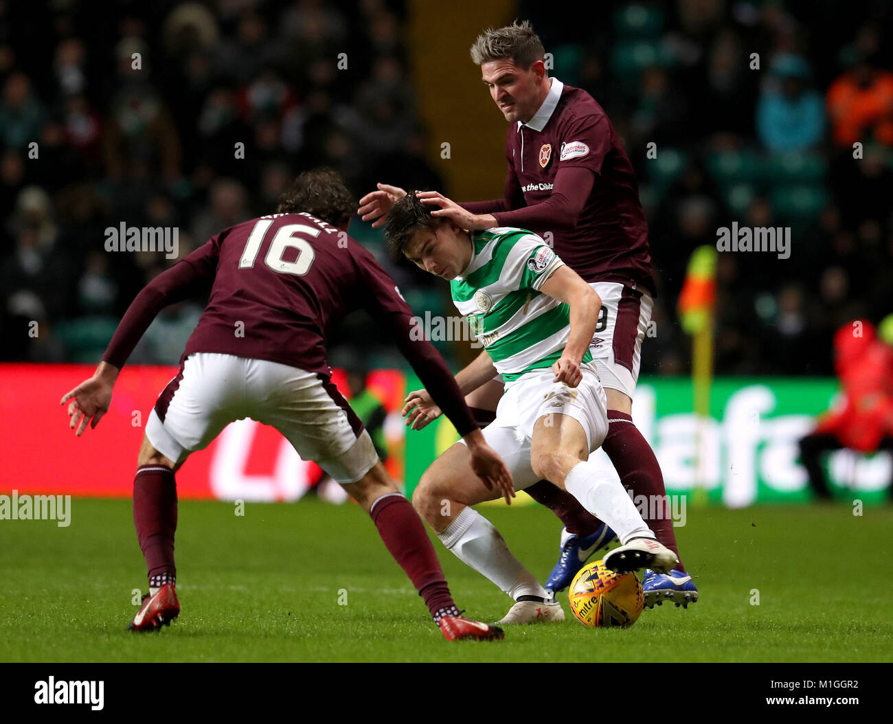Celtic's Kieran Tierney (centre) challenges Hearts' Kyle Lafferty ...