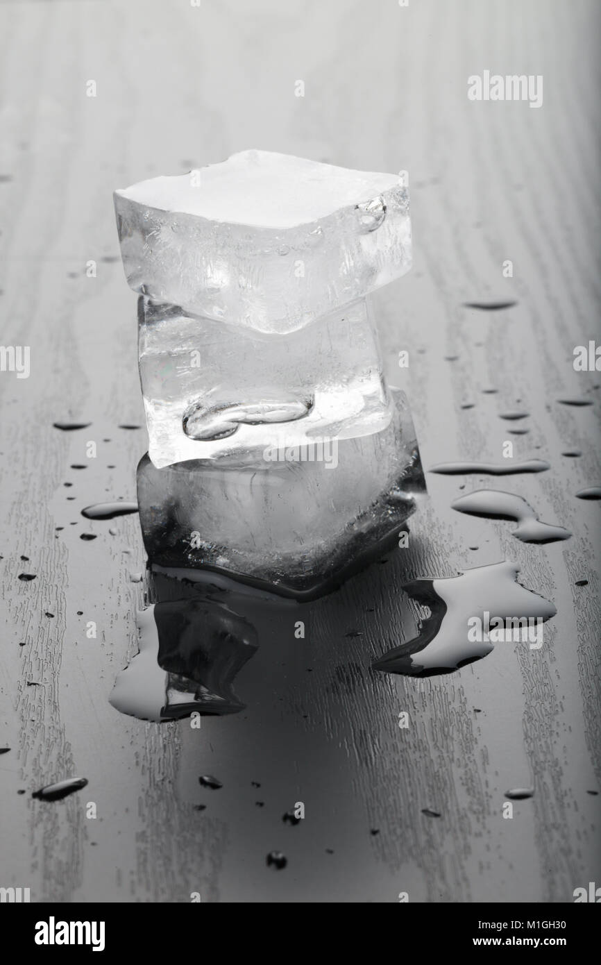 ice cubes on black table background Stock Photo - Alamy
