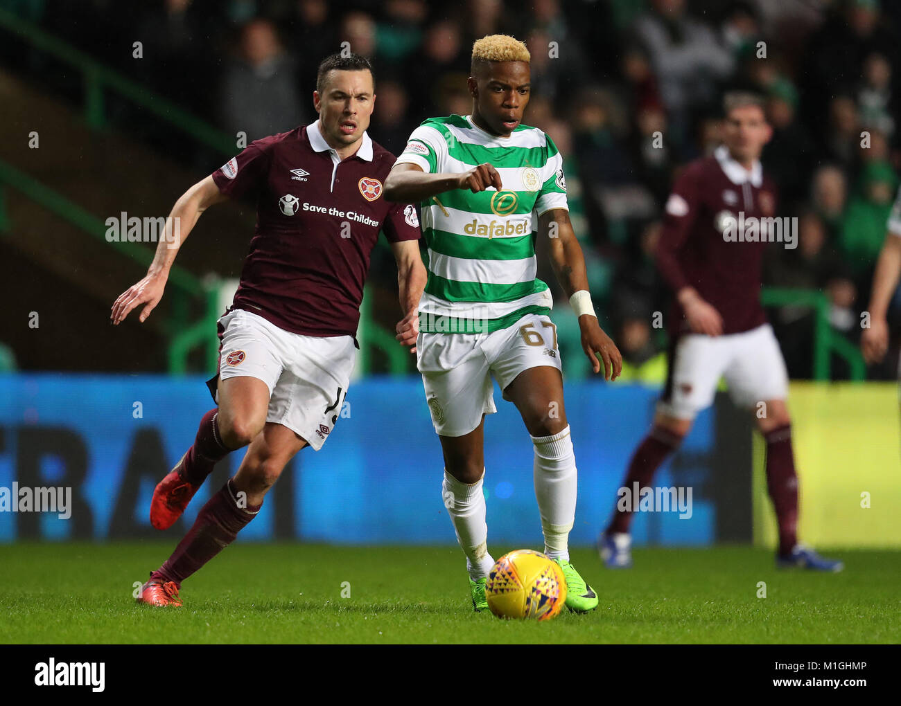 Celtic's Charly Musonda challenges Hearts' Don Cowie (left) during the ...
