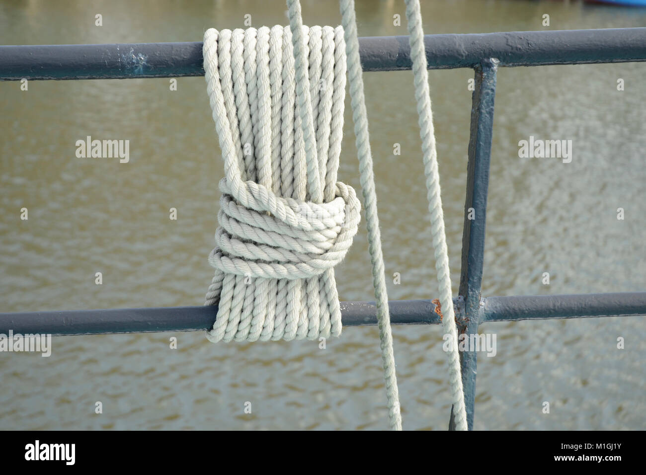 a rope hanging at a ship railing Stock Photo - Alamy
