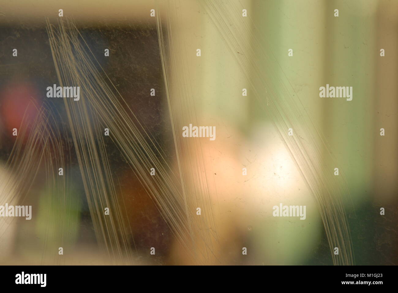 scratchings in a window with blurred background: green orange Stock ...