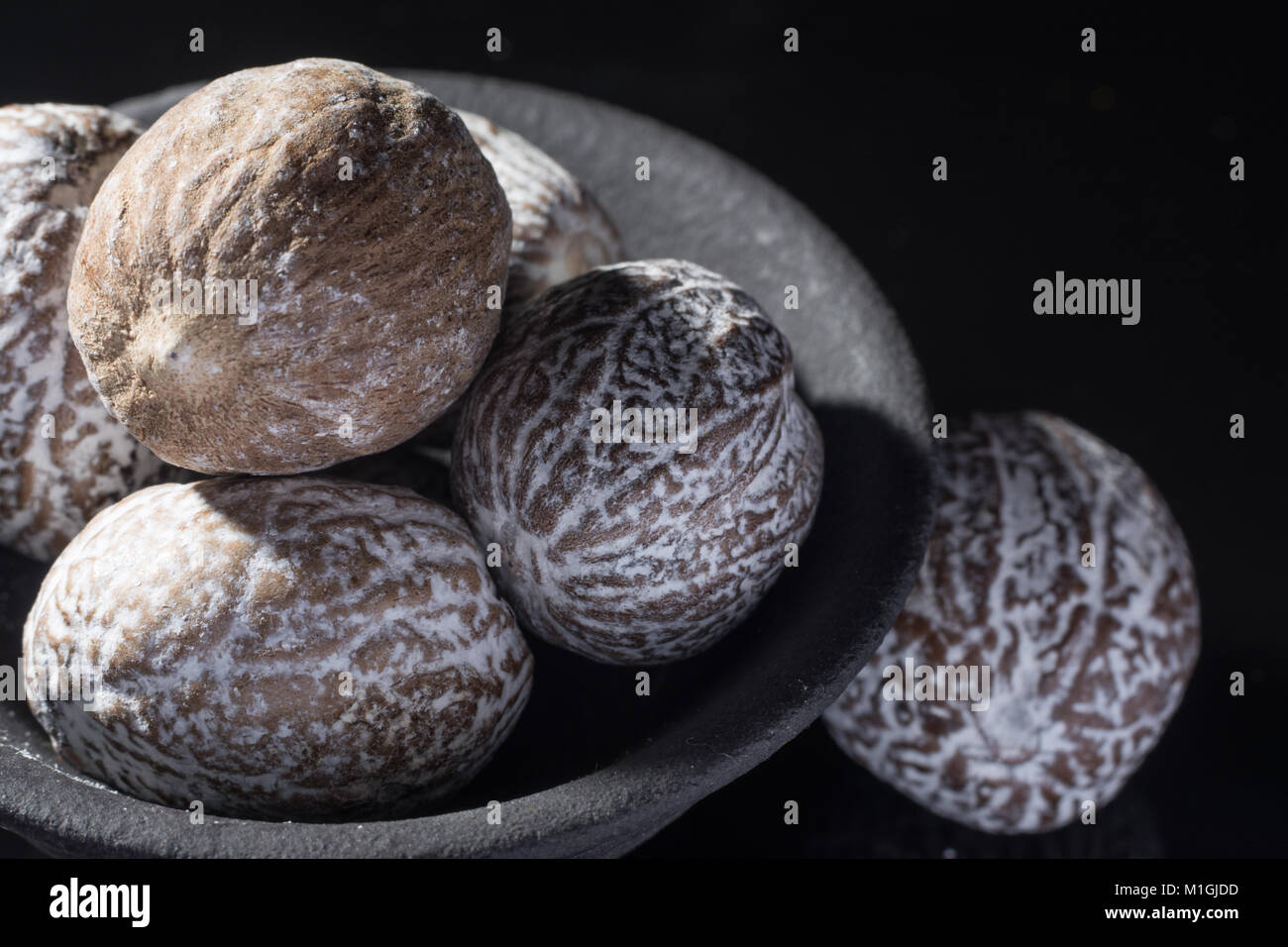 Macro collection, dried muscat nutmeg close up on black background ...