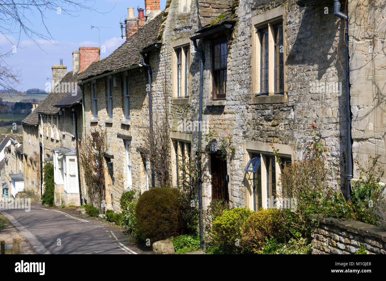 Quaint Cotswold cottages in early spring sunshine on The Hill, Burford ...