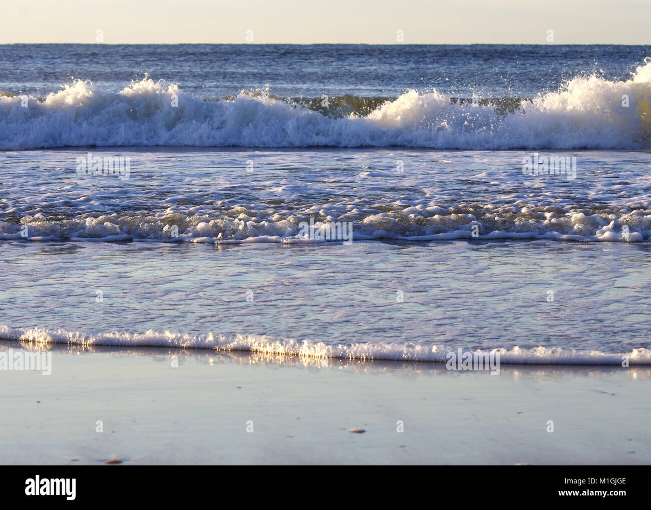 Waves breaking on the beach Stock Photo - Alamy