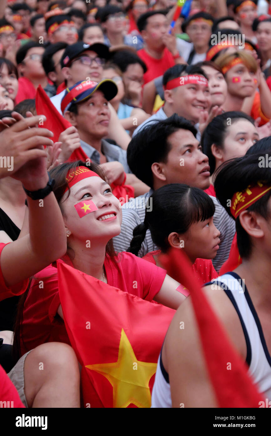 Portrait of Vietnamese football fans sit and watch AFC U23 soccer final ...