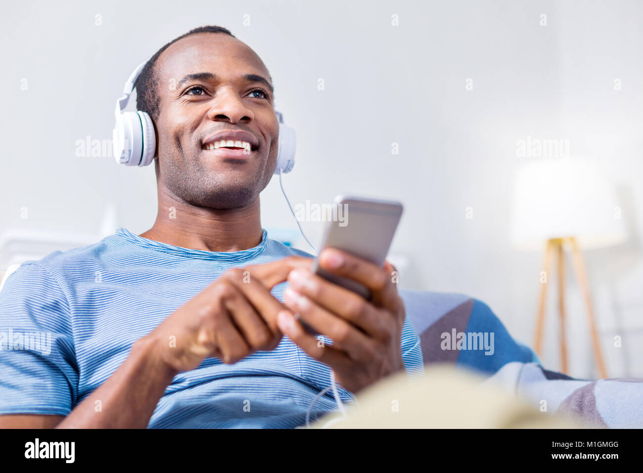Nice happy man enjoying the music Stock Photo - Alamy