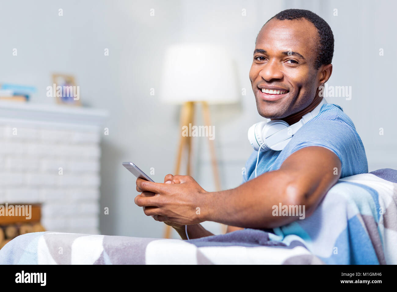 Positive young man using modern gadget Stock Photo - Alamy