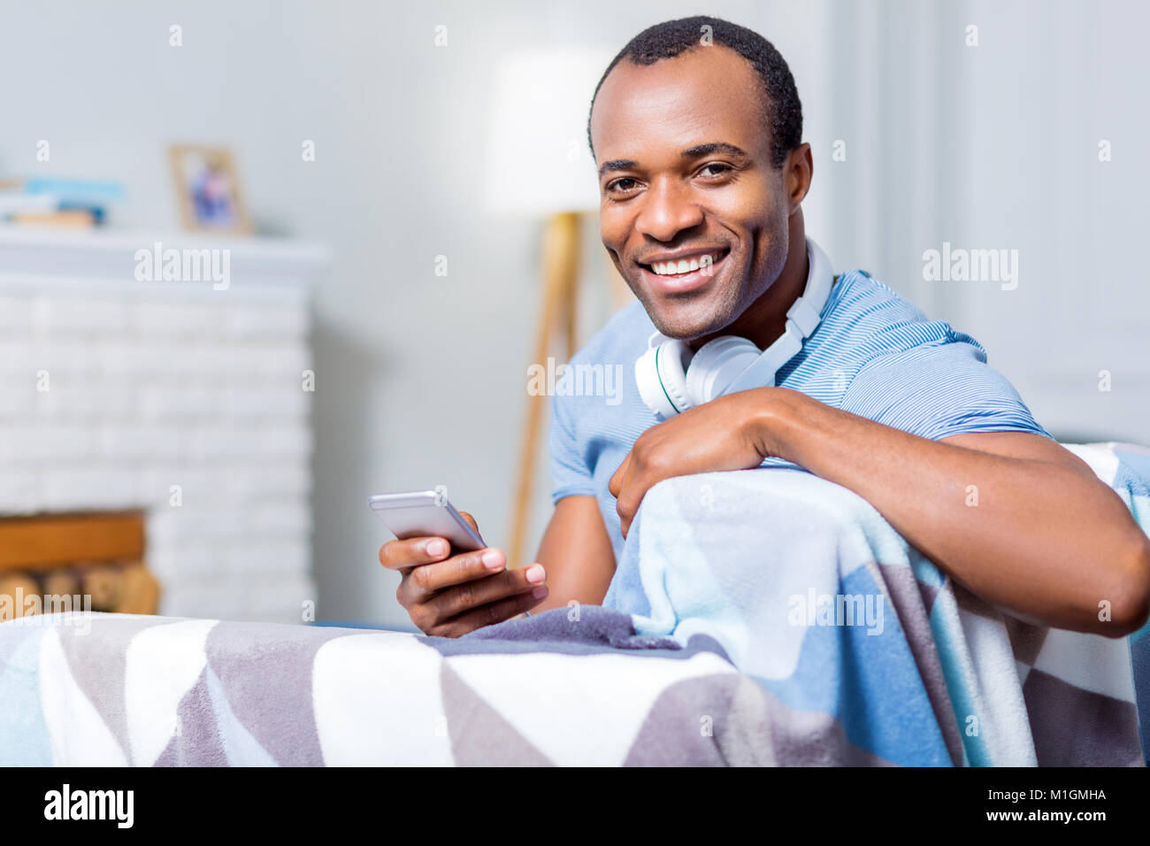 Joyful happy man holding his smartphone Stock Photo - Alamy