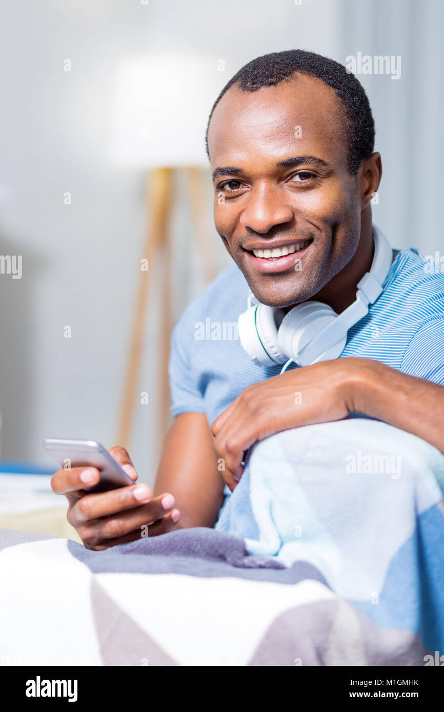 Cheerful happy man using his smartphone Stock Photo - Alamy