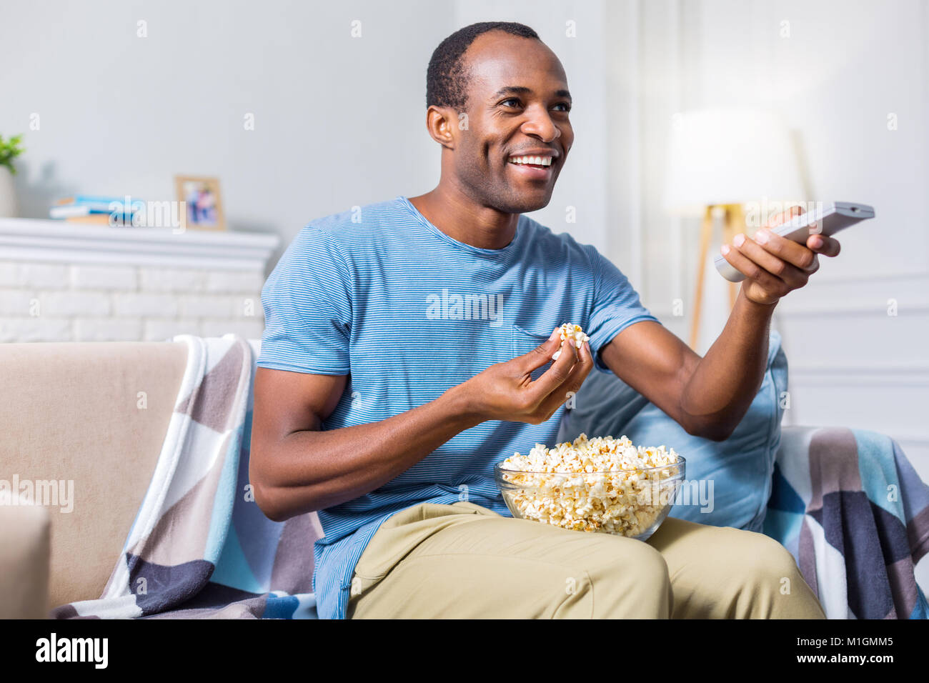 Delighted positive man watching TV Stock Photo - Alamy