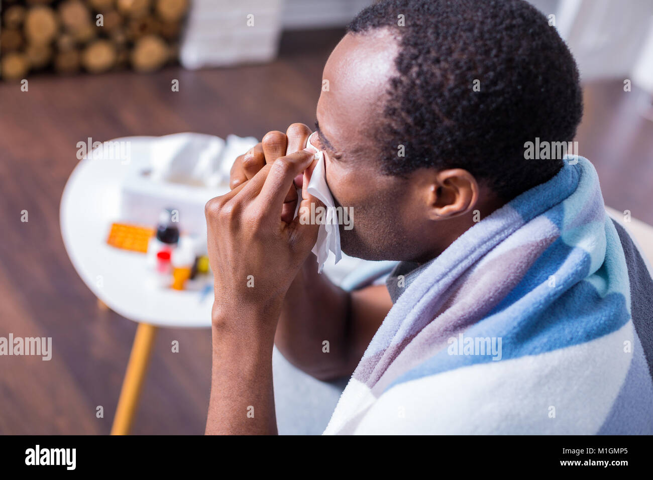 Unhappy sick man holding a paper tissue Stock Photo - Alamy