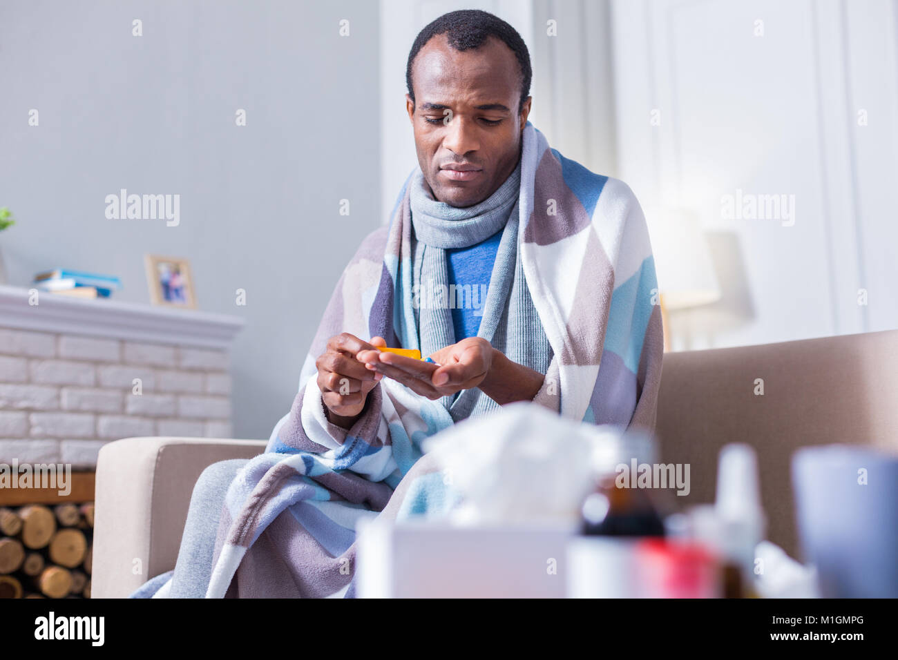 Cheerless sick man looking at his palm Stock Photo - Alamy